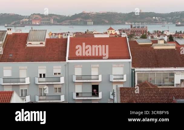 Beautiful rooftops with a serene waterfront view at dusk, highlighting ...