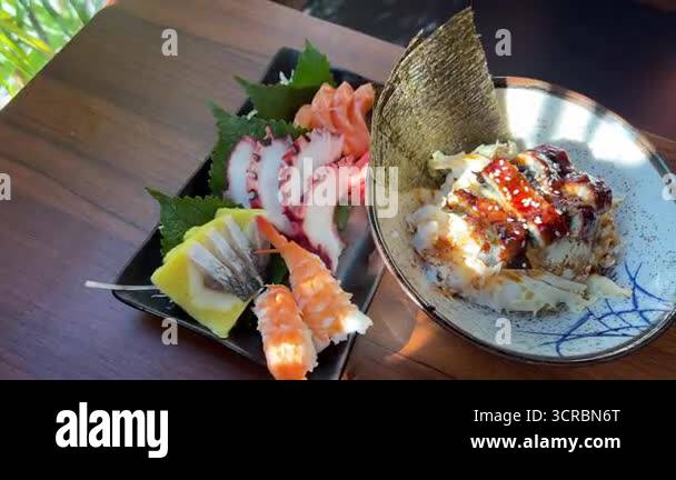 slice of tuna sashimi from an assorted Japanese sushi platter with ...