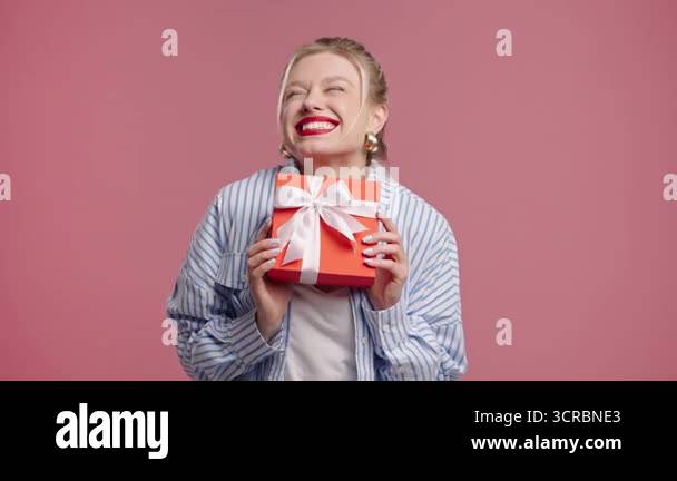 Happy stylish attractive woman gift box on pink background. Lady ...