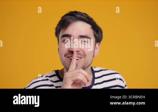 Handsome man with gesture of shhh, secret, silence, conspiracy, quiet ...