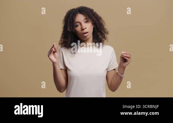 Young charming model mimics talking with hand while rolling her eyes ...