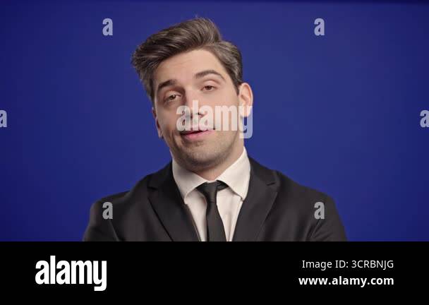 Tired handsome businessman sighs, rolling eyes on blue background ...