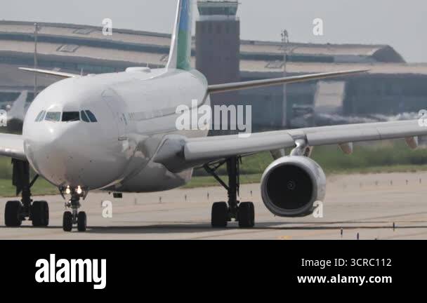 large white jumbo jet taxiing inside barelona airport with heat haze ...