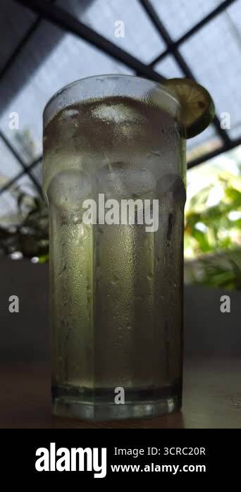 Fresh lime with ice cubes in a glass, refreshing citrus drink perfect ...