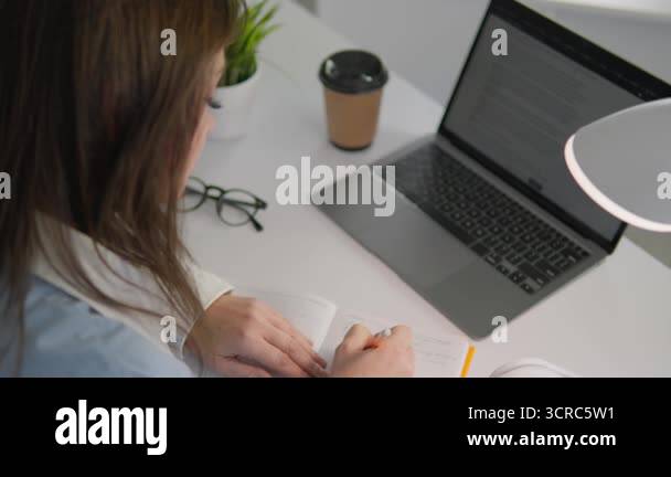 In a productive learning environment, a focused student takes notes on ...