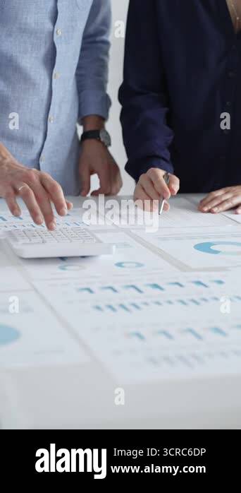 Business colleagues are working together, analyzing financial charts ...