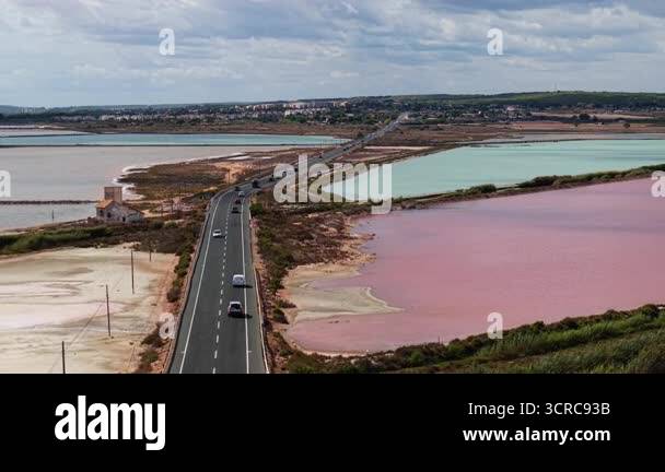Aerial view of road crossing colorful salt lagoons near Santa Pola ...