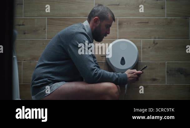 Businessman Using Smartphone, Sitting on Toilet. Man Scrolling Social ...