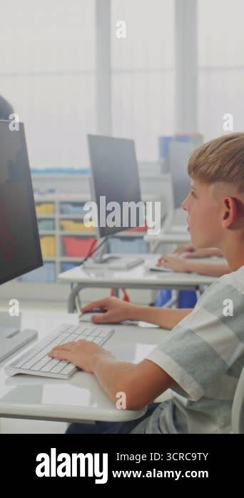 Primary School Students Painting Pictures on Computers, Working on ...