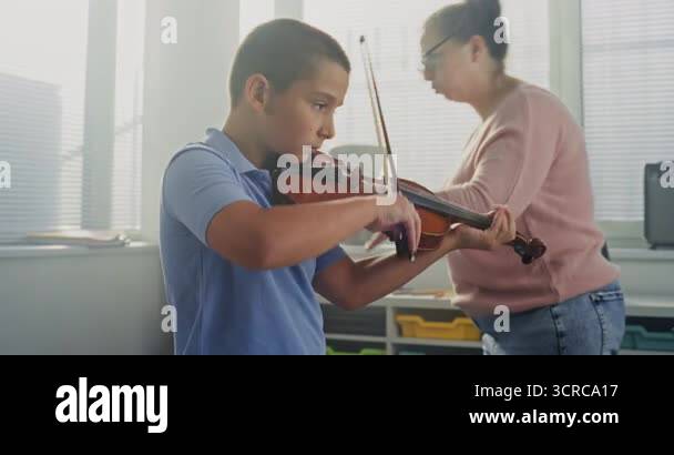 Primary School Boy Practicing Violin in Music Class, Dreaming to Become ...