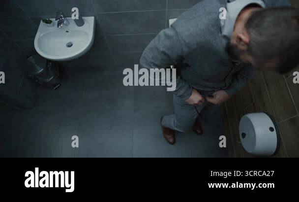 Man Entering in Restroom, Sitting on the Toilet and Suffering from ...