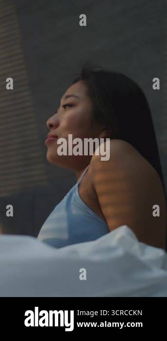 Beautiful Young Woman Wakes Up in Cozy White Bed. Smiling Sleepily ...