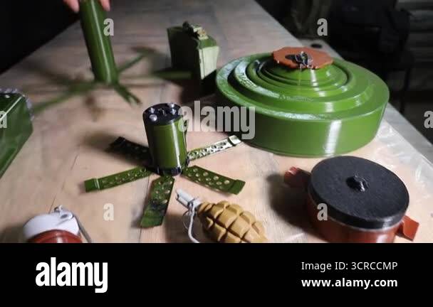 Various types of mines, grenades and explosives on the table. Military ...