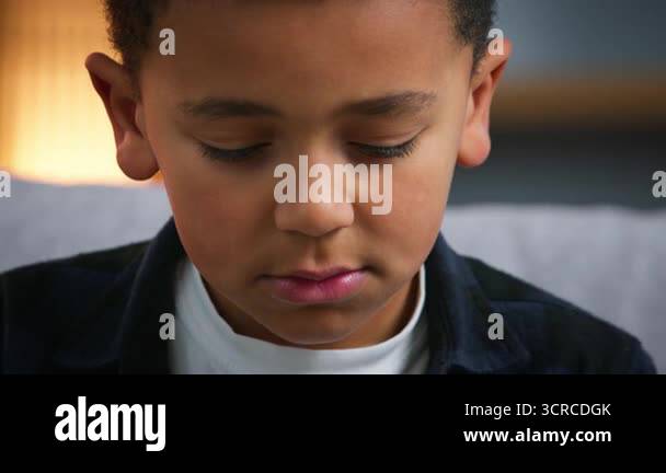 Close up sad upset little African American boy thinking pensive sadness ...