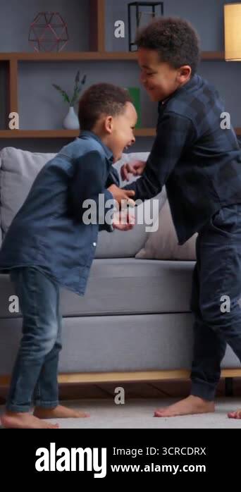 Two little African American boys fighting at home family children ...