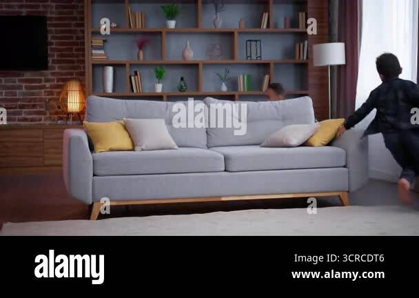 Happy two little African American kids running in living room joyful ...