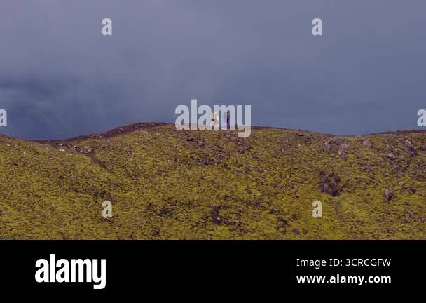 Drone captures a moss covered volcanic hill in Iceland, with a small ...