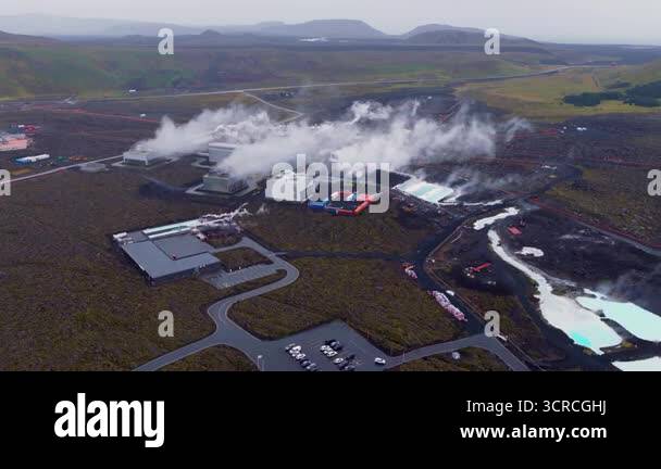 Geothermal power plant in Iceland with steam rising from vents ...