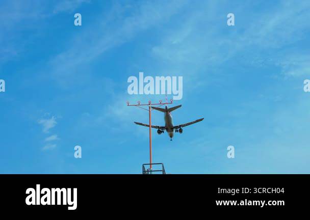 Rear view of commercial airplane flying overhead during landing ...
