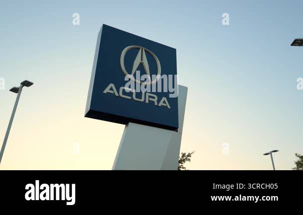 Illuminated sign post of Acura dealership on twilight blue sky ...