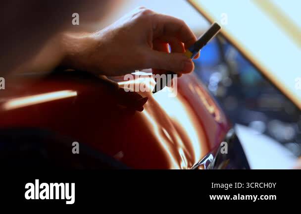Close up view of Process of pointless dent repair on car body, mechanic ...