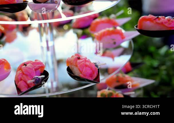 Arranged sushi platter served on an elegant multi-tiered display stand ...