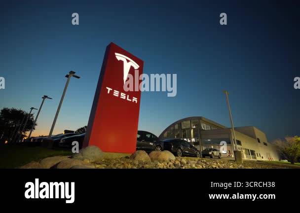 Post near exterior of the Tesla dealership with twilight evening sky ...