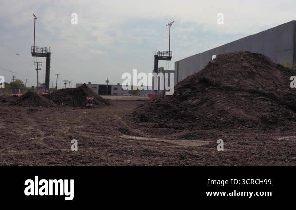 Construction site with piles of soil and concrete walls. Industrial ...