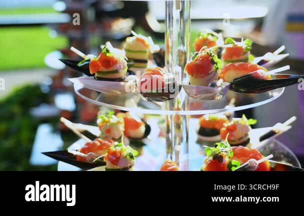 Arranged sushi platter served on elegant multi-tiered display stand ...