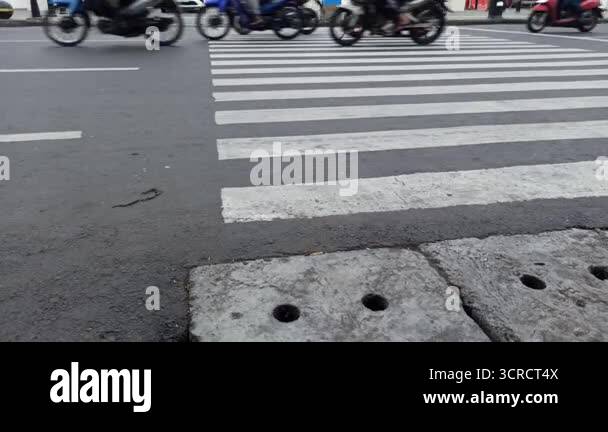 Zebra cross on a city street with clear white stripes, symbolizing ...