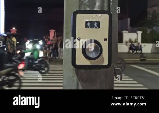 Close-up of pedestrian crossing button at zebra cross, symbolizing ...