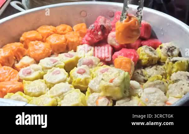 Freshly steamed dim sum inside a bamboo steamer, showcasing its soft ...