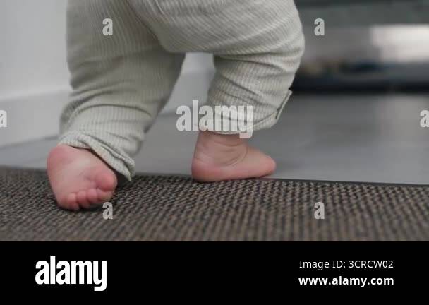 An unrecognizable baby explores his surroundings while honing his ...