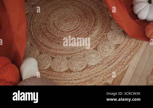 Warm jute rug with circular pattern, autumn pumpkins, and orange fabric ...