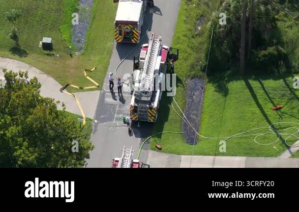 Firefighter trucks at fire alarm scene of suburban house. First ...