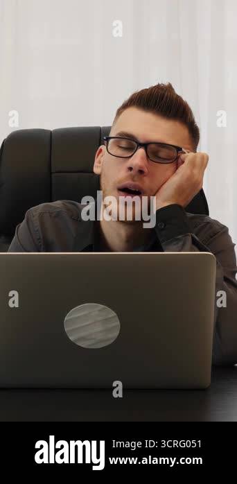 Bored at work man is falling asleep at office desk. Sleepy tired male ...