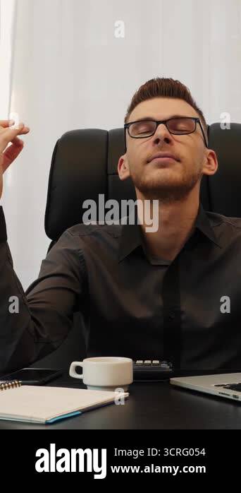Man sitting at his office desk in dzen position and meditating. Male ...