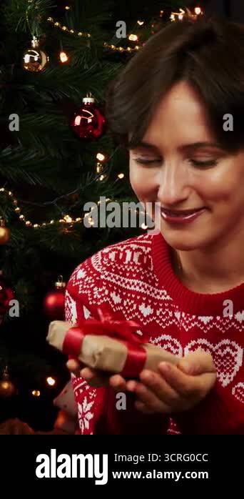 Happy woman holding and shaking present box with Christmas gift with ...