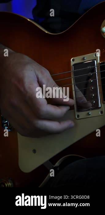 Hands of guitarist playing on guitar strings, close up. Male guitarist ...