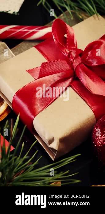 Wrapped with red ribbon gift box and christmas decorations rotating ...
