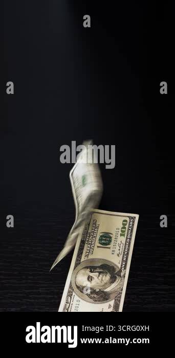 Vertical video of cash money falling on black background. One hundred ...