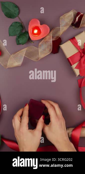 Hands are opening little red box with engagement ring for St. Valentine ...