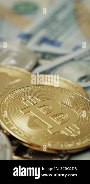 Bitcoins rotating on dollars bills background. Vertical video ...