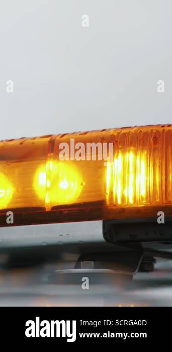 Ambulance with flashing yellow lights, close up. Flashing yellow ...