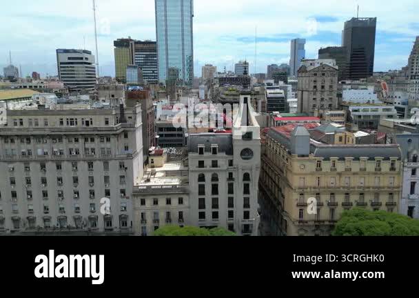 Dynamic aerial view moving sideways over a narrow street in downtown ...