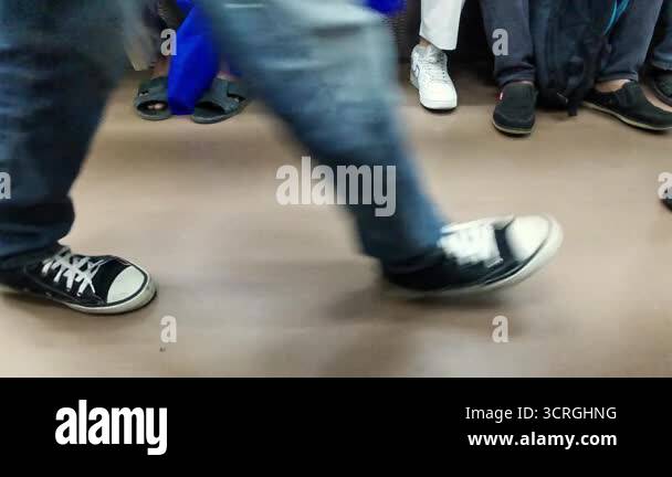 a-low-angle-view-of-the-variety-of-footwear-and-foot-movements-of