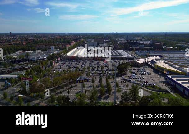 Aerial view of Berlin hardware store with parking lot and city ...
