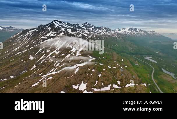 Snow-capped mountains in Alaska landscape. Aerial view of dramatic snow ...