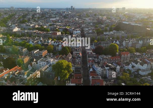 Aerial sunrise views of a vibrant Amsterdam city highlight its lush ...