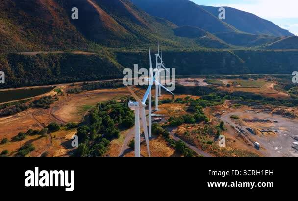 Valley with a wind farm near the mighty rocks. Green energy production ...